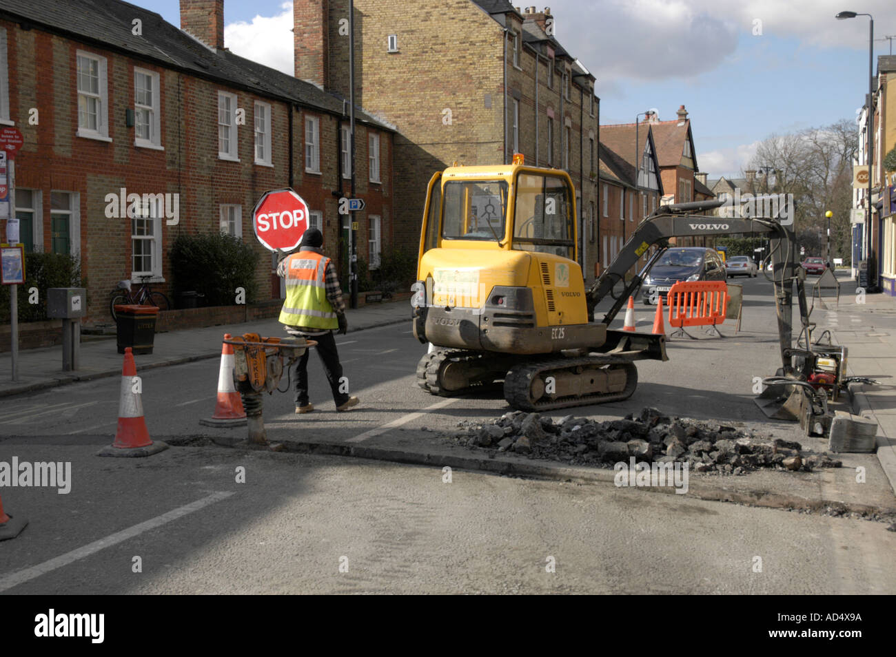 stop go sign and workers at road works Stock Photo - Alamy
