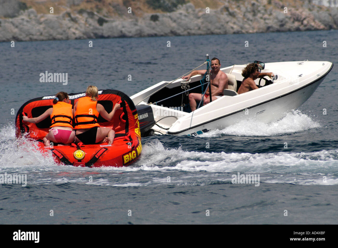 Riding Big Mable an orange surf inflatable Stock Photo - Alamy