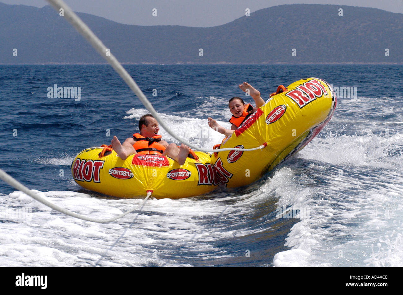 pair enjoy riding the water donut Stock Photo - Alamy