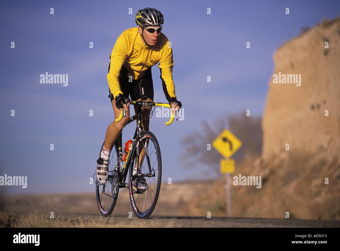 Male cyclist riding uphill Stock Photo - Alamy