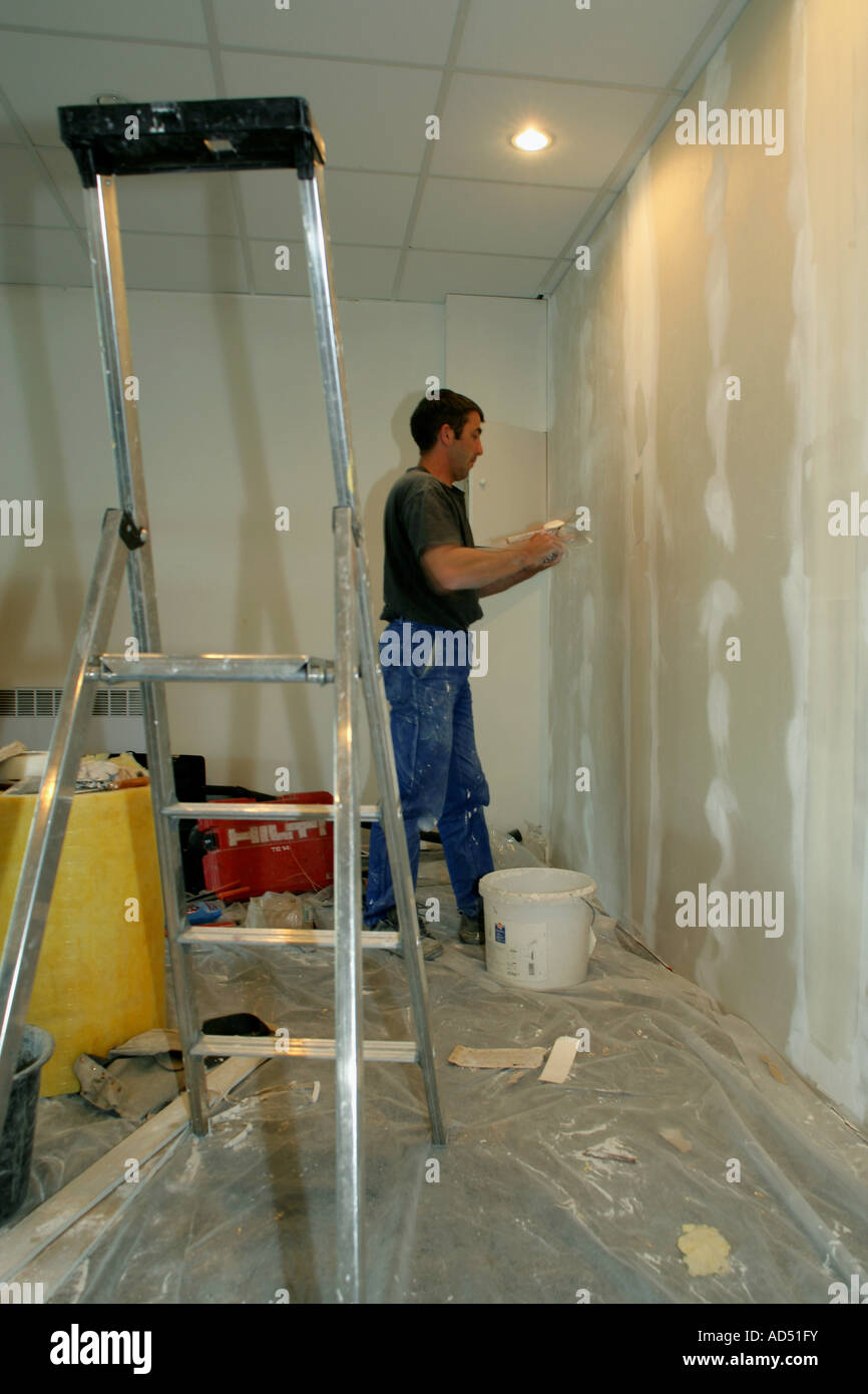 Man working on a wall Stock Photo - Alamy