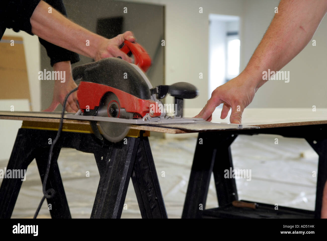Workers using a cutting tool Stock Photo - Alamy