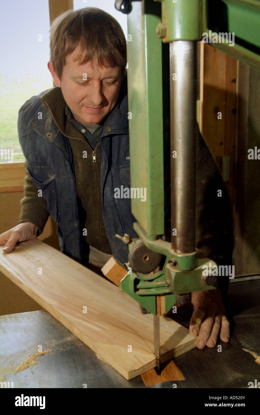 Woodworker cutting a piece of wood Stock Photo - Alamy