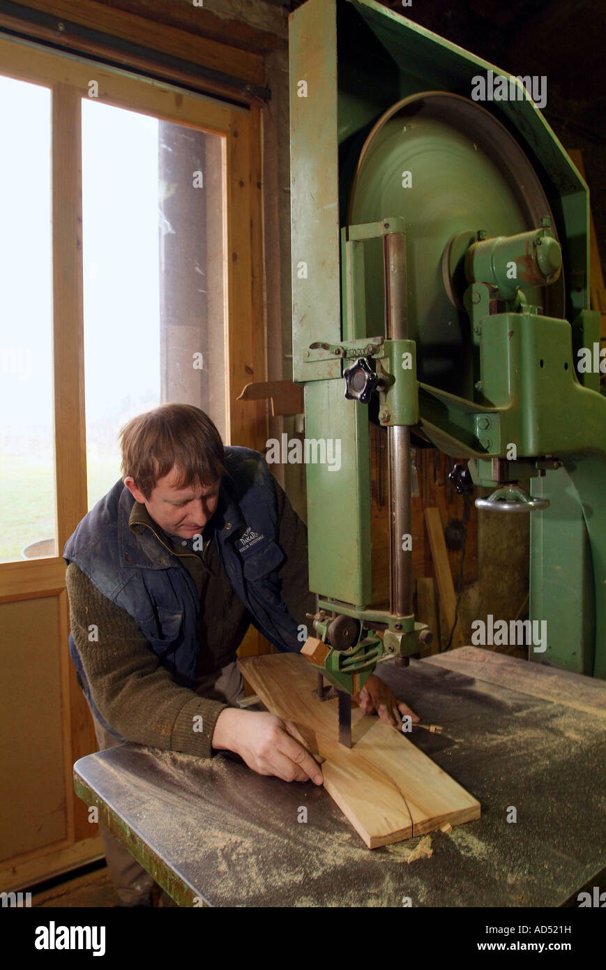 Woodworker cutting a piece of wood Stock Photo - Alamy