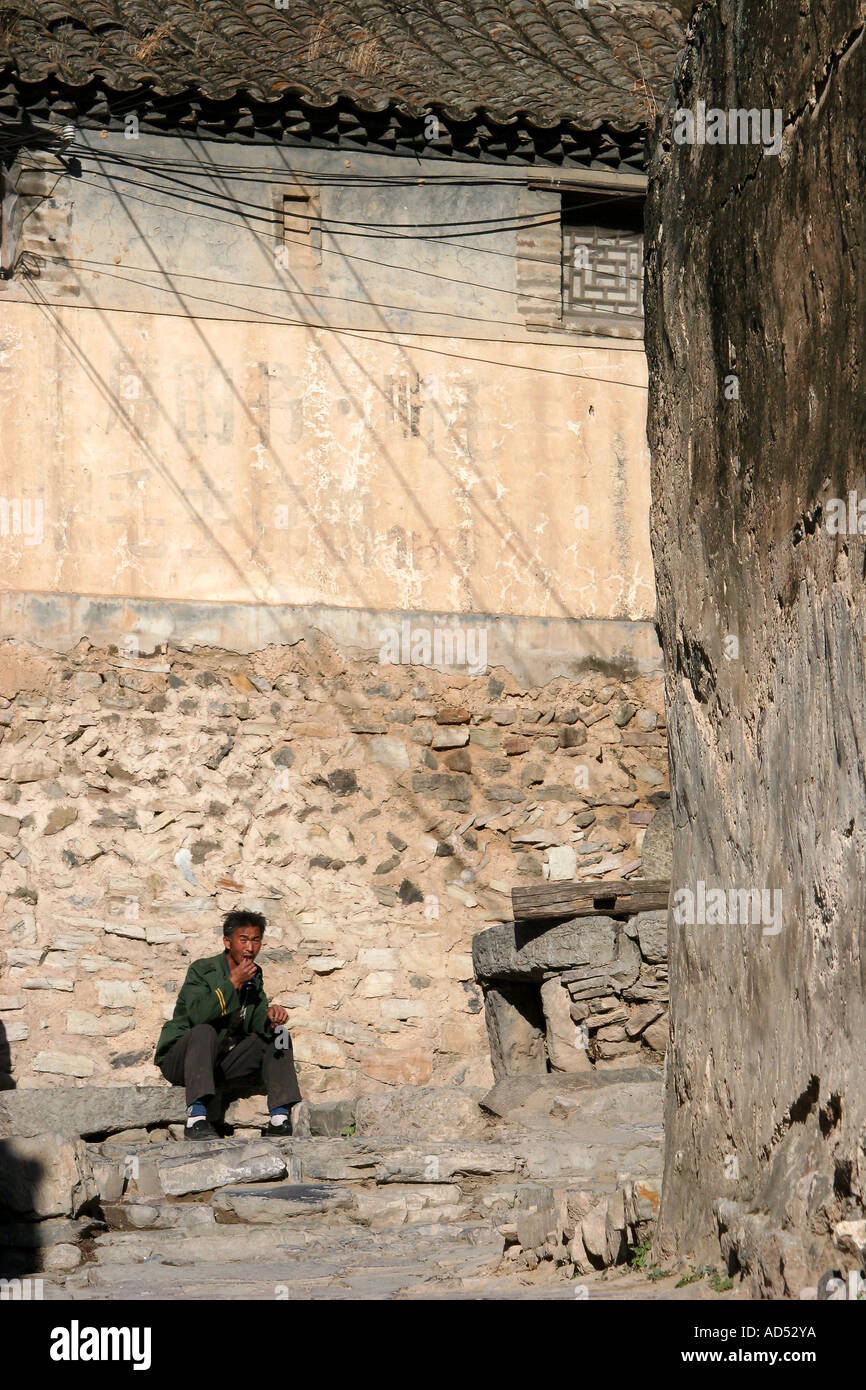 Chinese man in the streets of the traditional Chinese village of ...