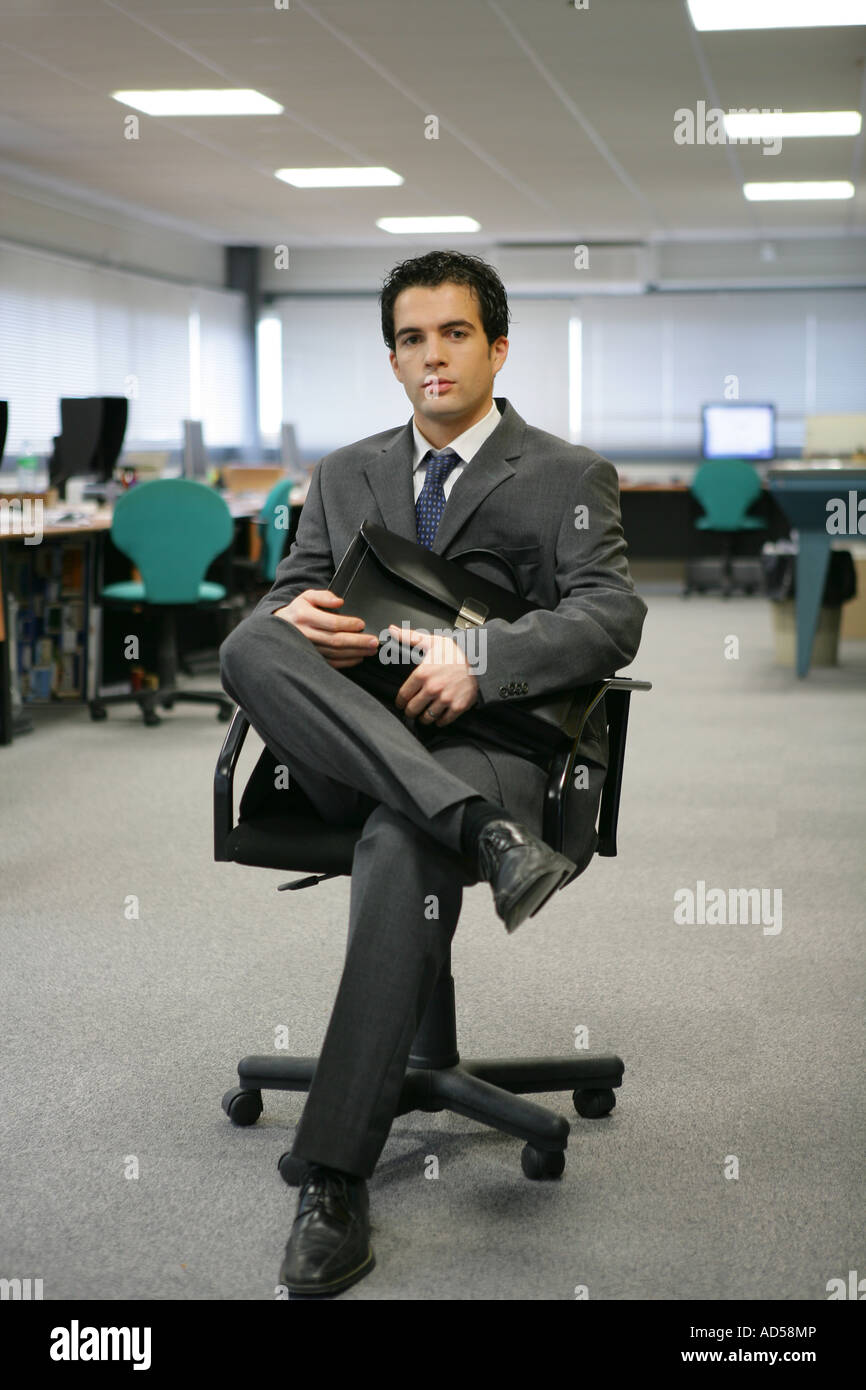 Young professional sitting on a chair Stock Photo - Alamy