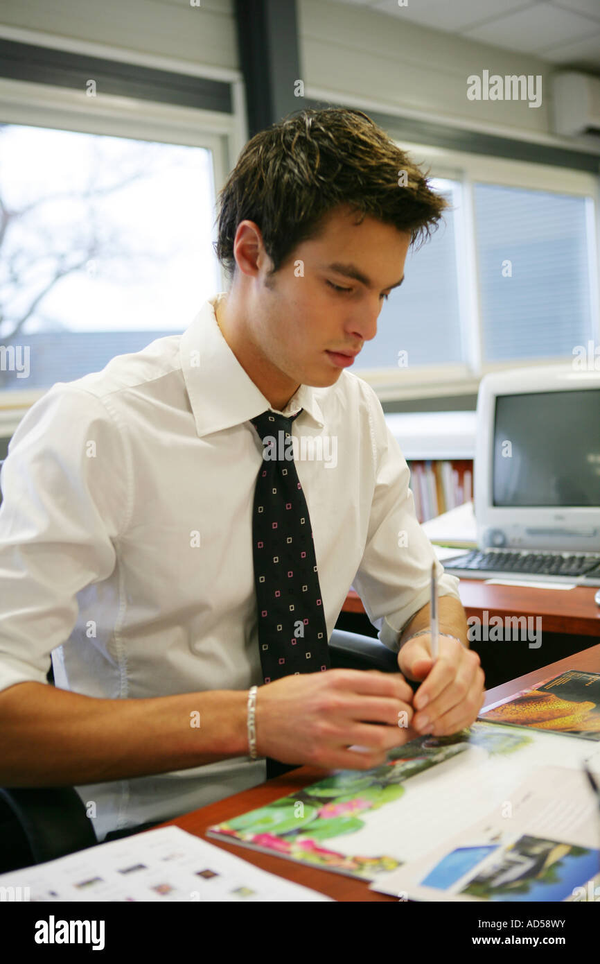 Young professional sitting at his desk Stock Photo - Alamy