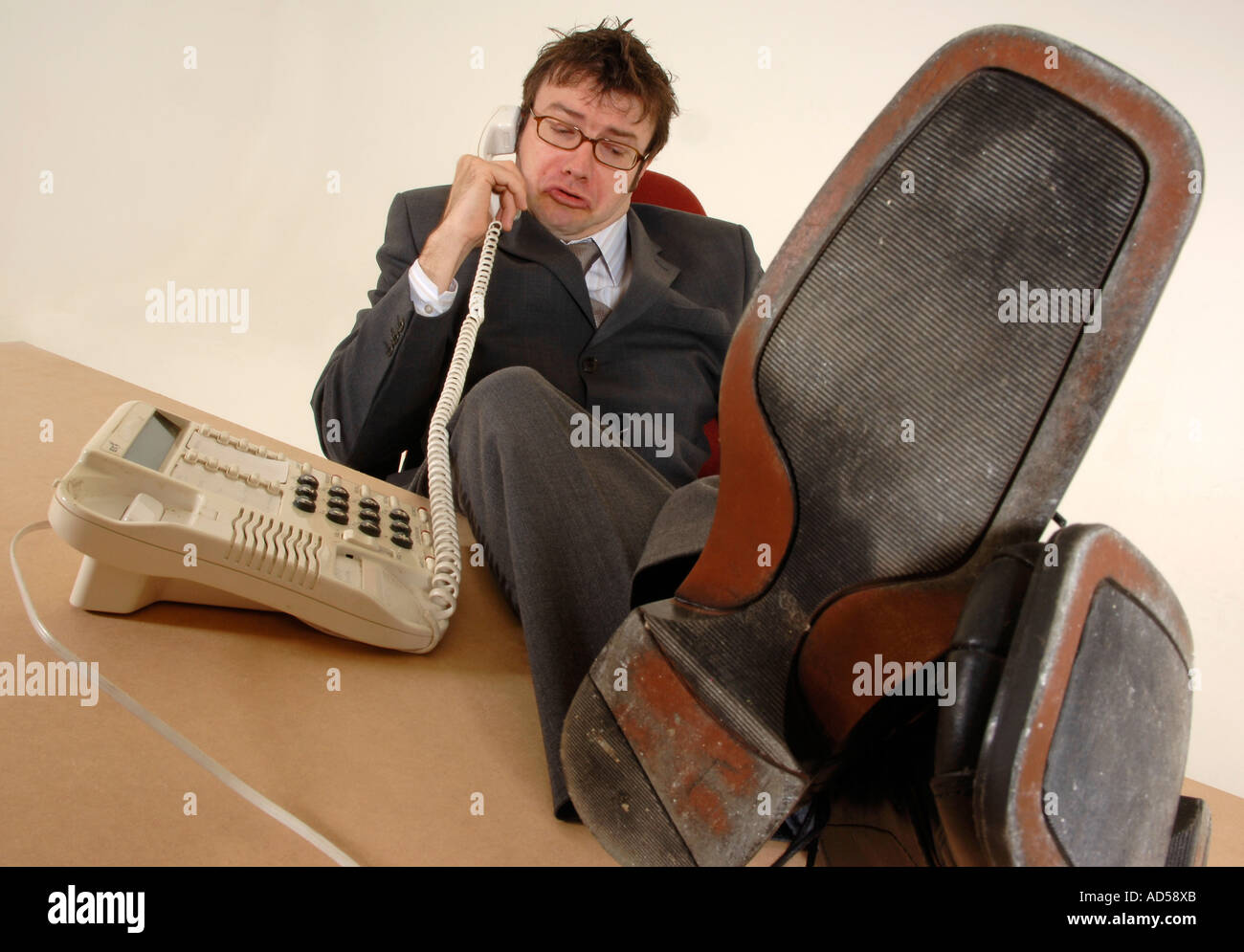 Telephone sales person making a call with feet on the desk Stock Photo ...