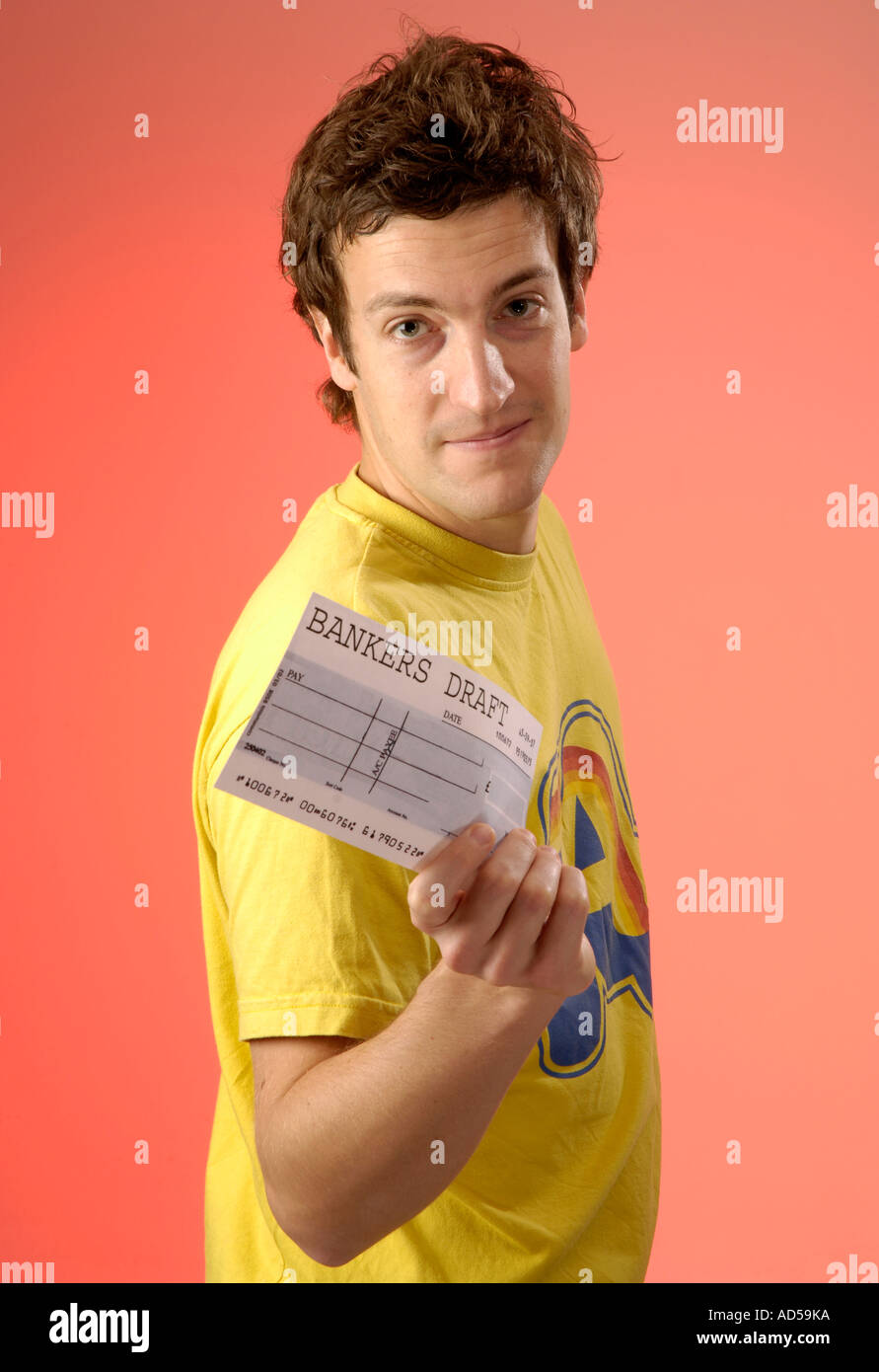 Young man offering a bank cheque Stock Photo - Alamy
