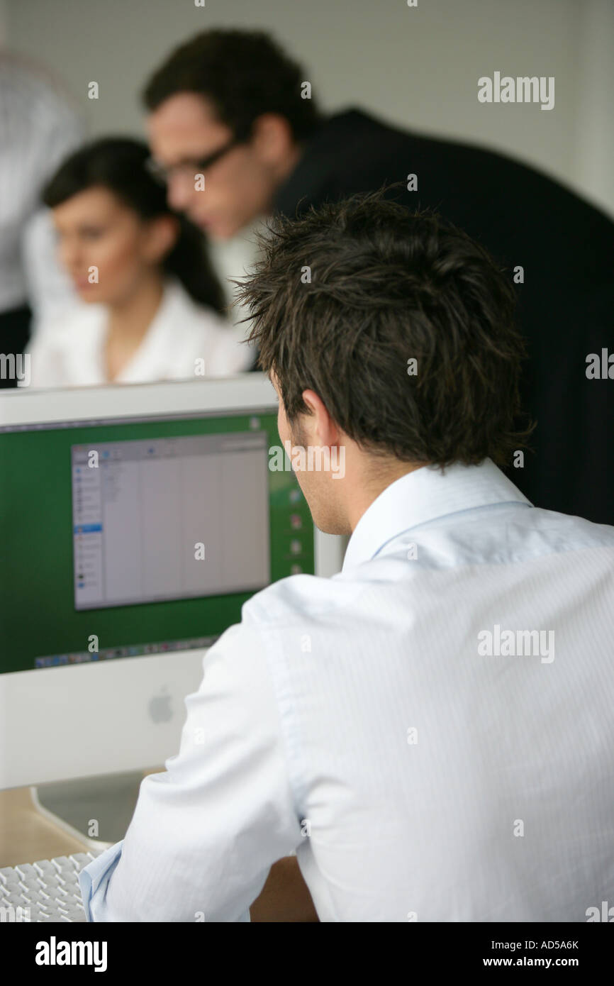 Young professionals using computers Stock Photo - Alamy