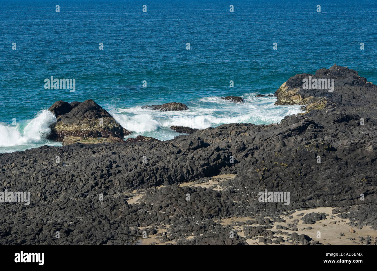 waves from the sea come splashing and crashing into the rocks Stock ...
