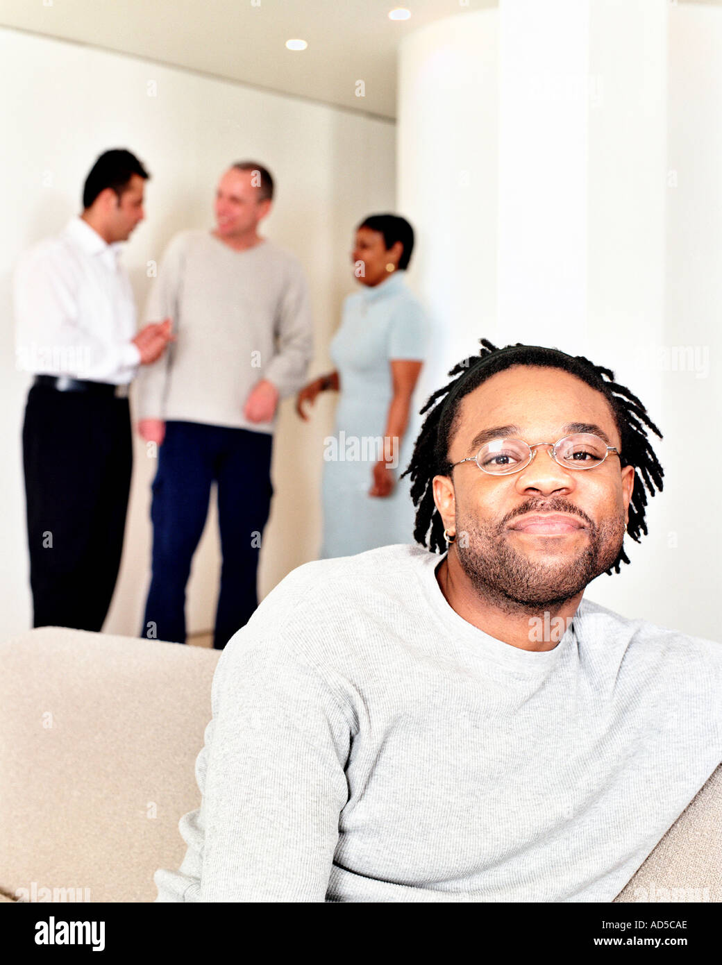 Trendy young adults chatting and smiling Stock Photo - Alamy Trendy young adults chatting and smiling Stock Photo - Alamy