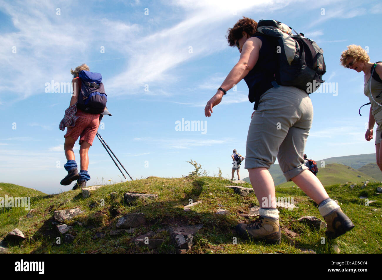 Guided walking group on rocky footpath at Castell Dinas in the Black ...