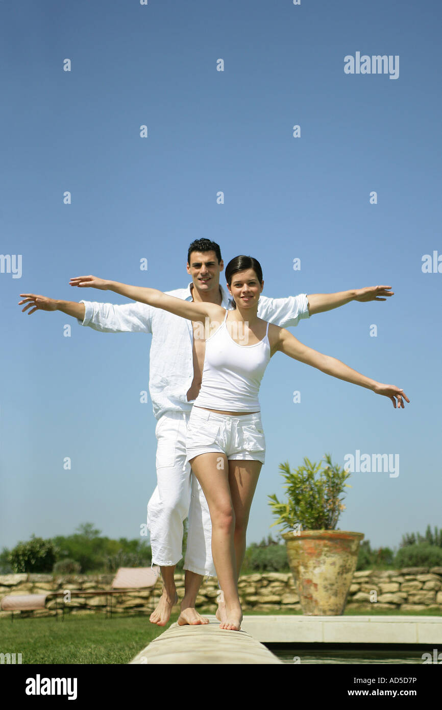Young couple having fun by the swimming pool Stock Photo - Alamy