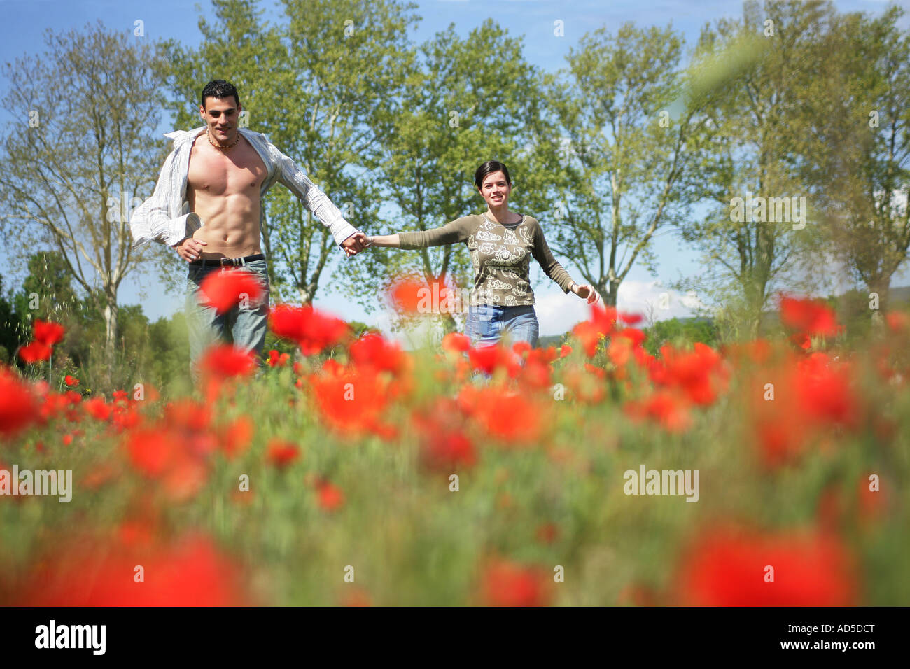 Man and woman running field flowers hi-res stock photography and images ...