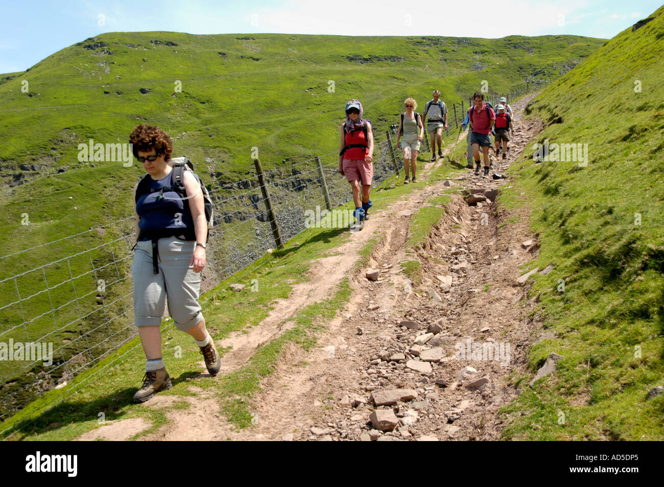 Guided walking group heading down byway at Rhiw Cwnstab in the Black ...