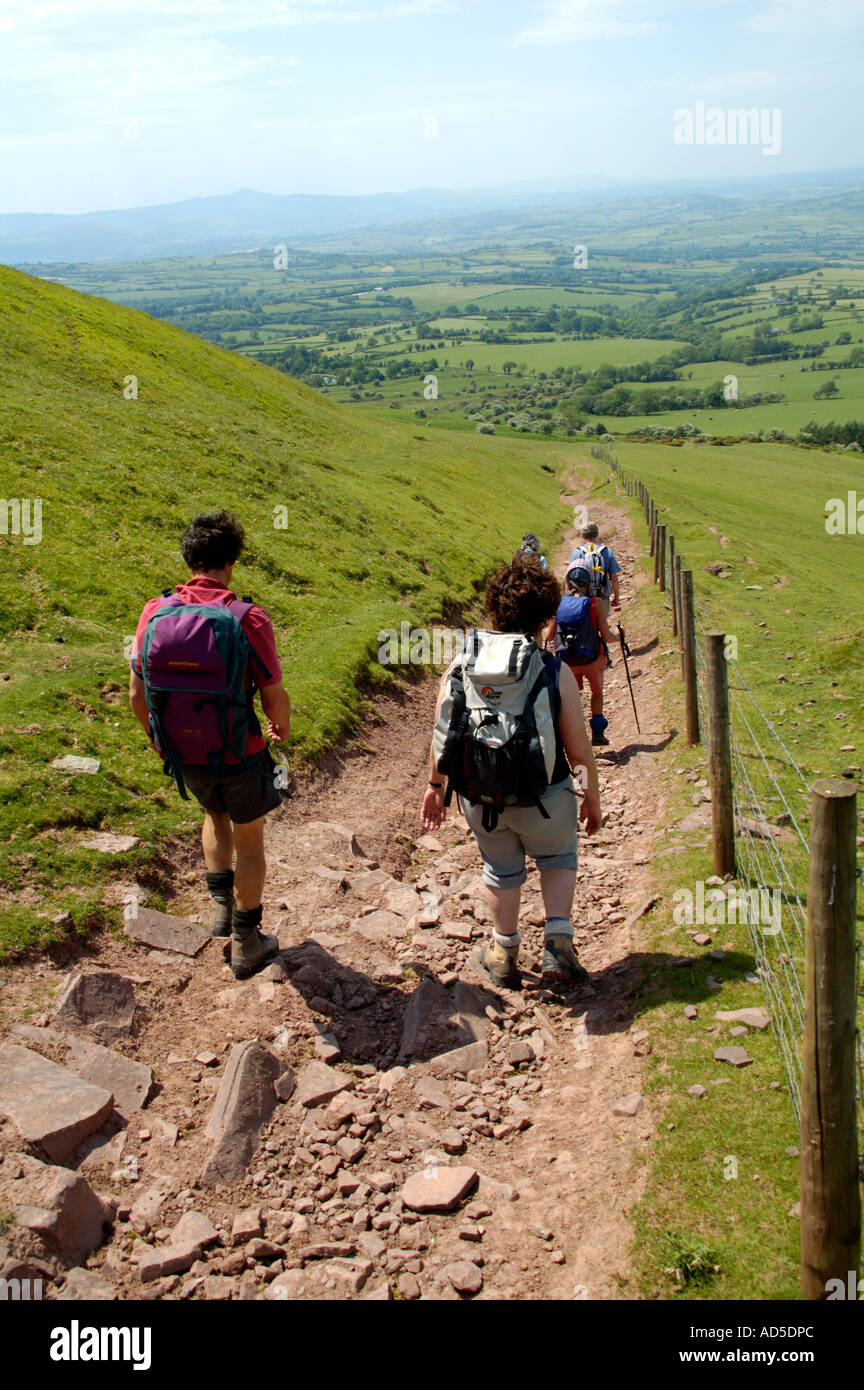 Guided walking group heading down rocky byway at Rhiw Cwnstab in the ...