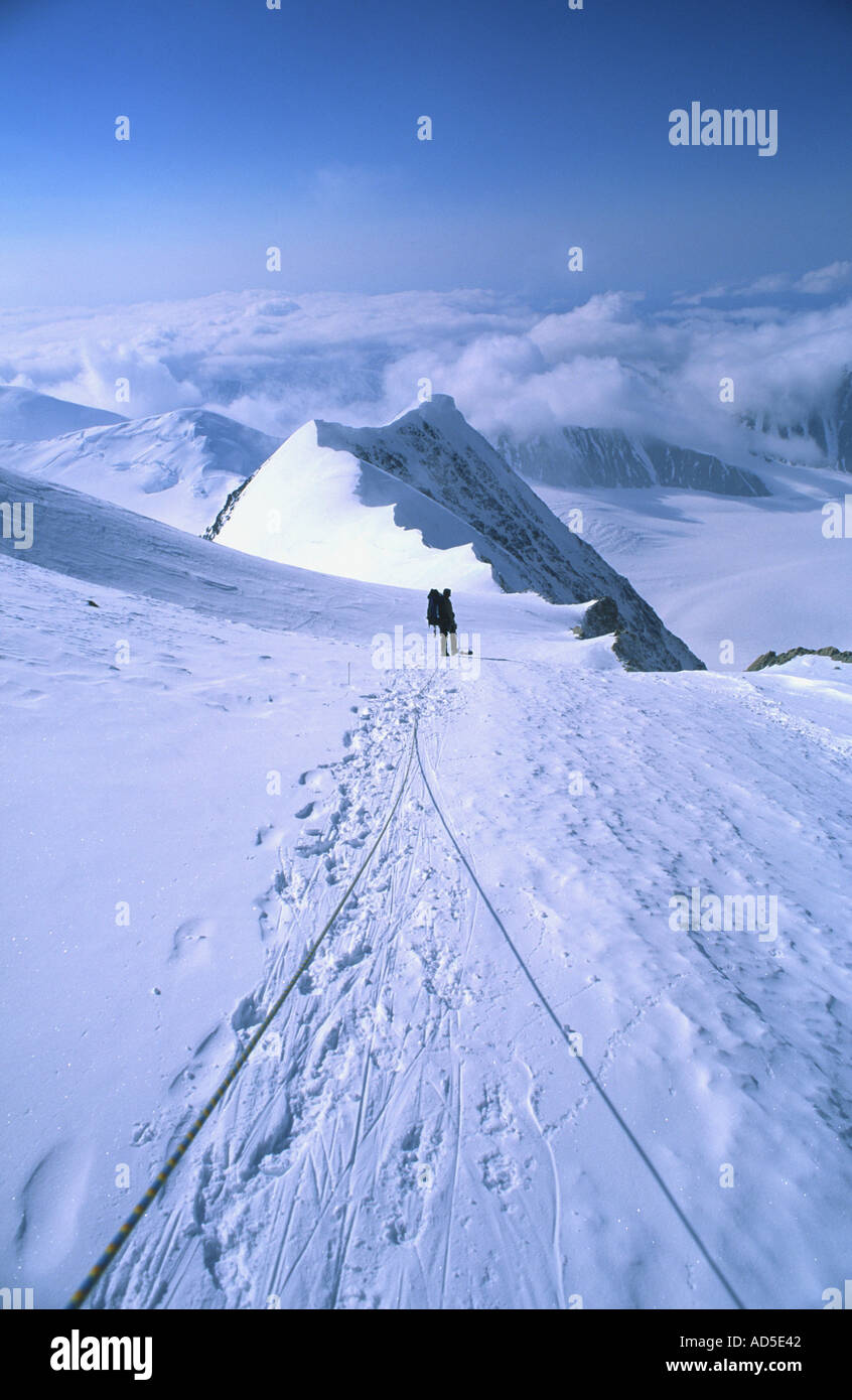 A mountaineer descending above a ridge on the West Buttress route ...