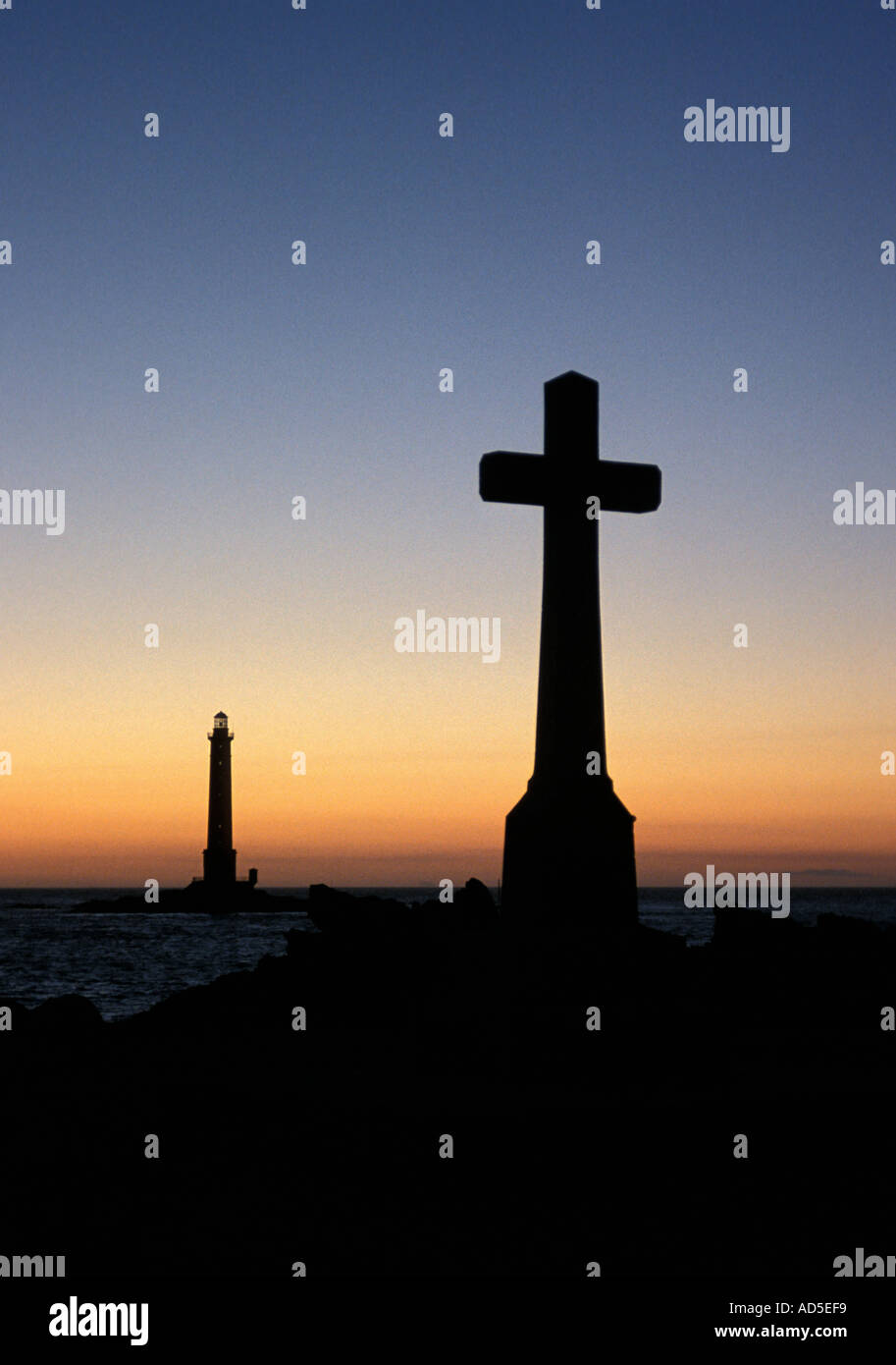 Cross and lighthouse at dusk Stock Photo - Alamy