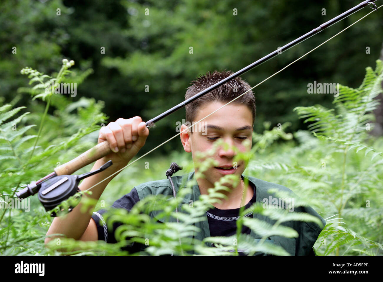 Boy holding fishing line hi-res stock photography and images - Alamy
