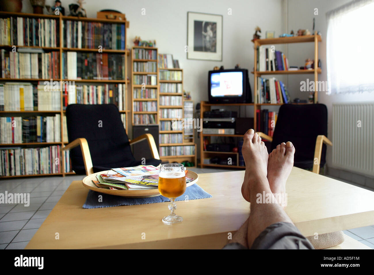 Man watching TV and relaxing Stock Photo - Alamy