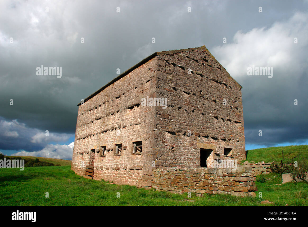 Defiant against the storm, old, traditionally built stone barn Stock ...