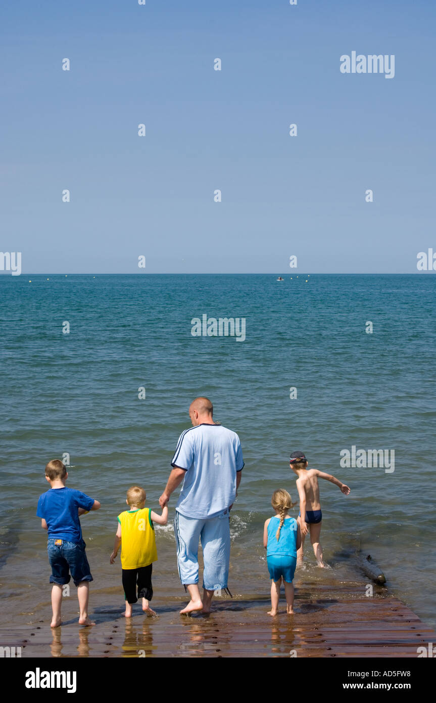 Children paddling in the sea hi-res stock photography and images - Alamy