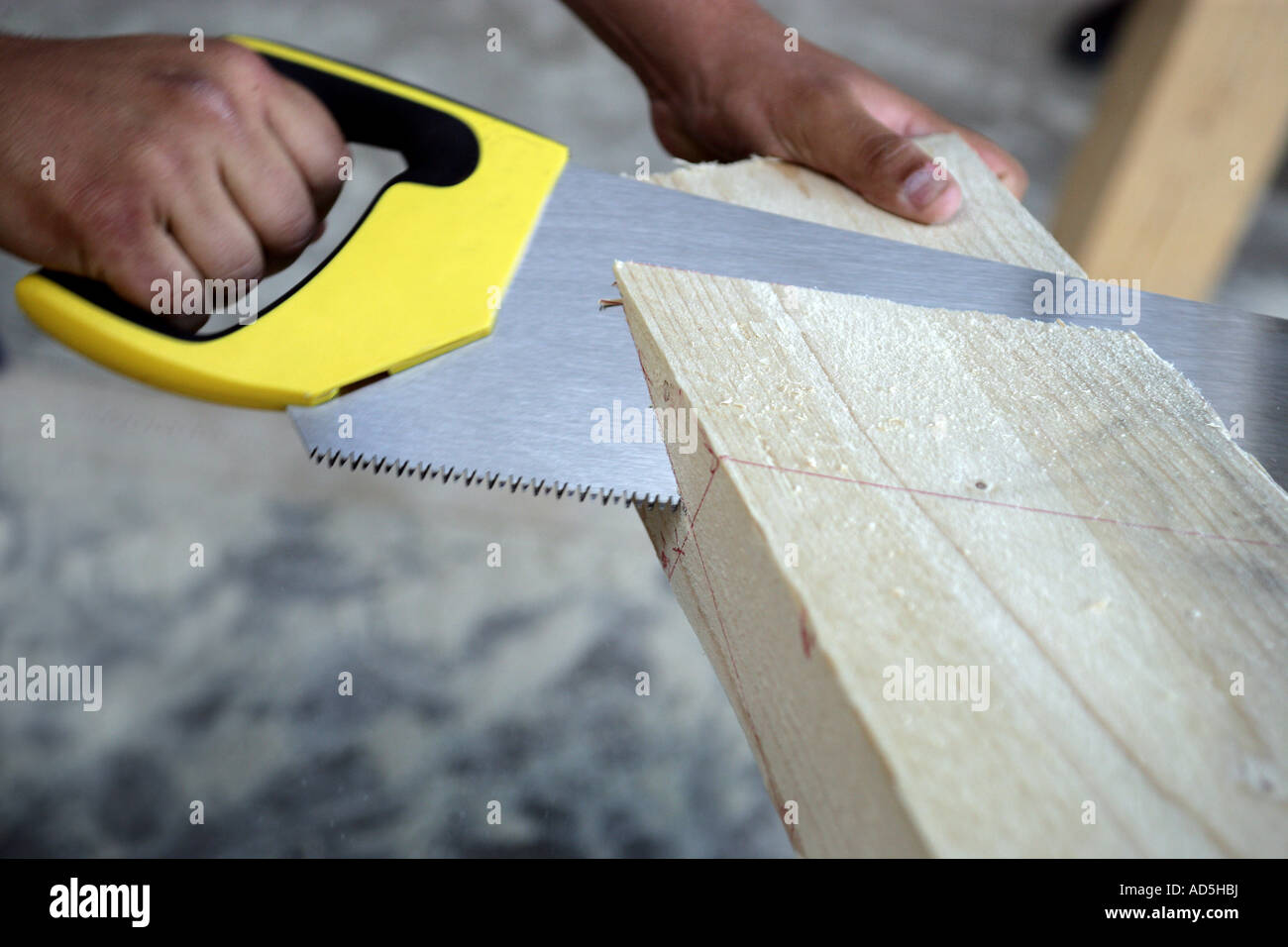 Carpenter using a wood saw Stock Photo - Alamy