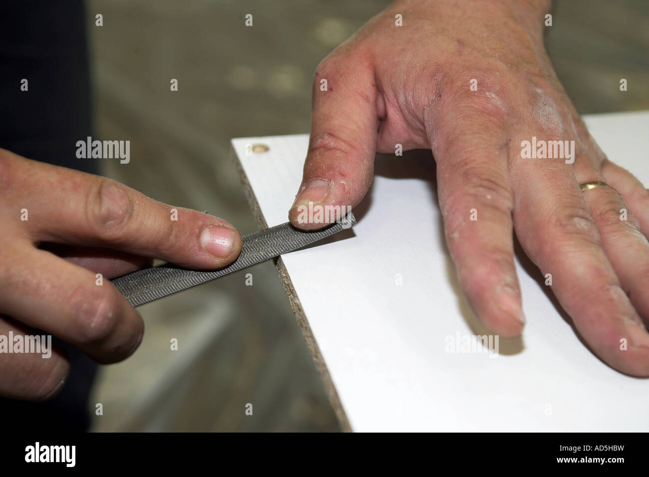 Worker filing a wooden surface Stock Photo - Alamy