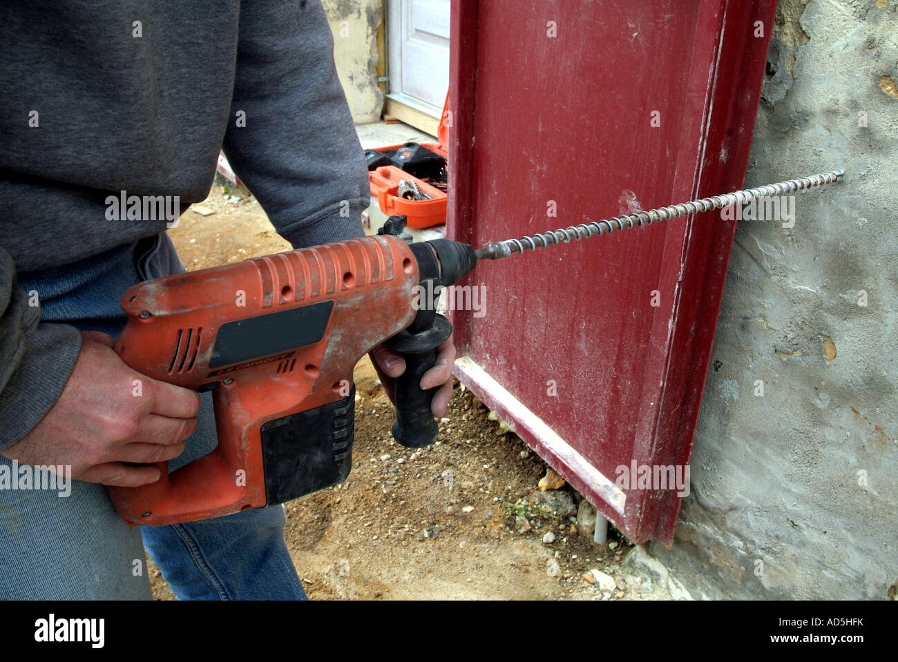 Worker using an electric drill Stock Photo - Alamy