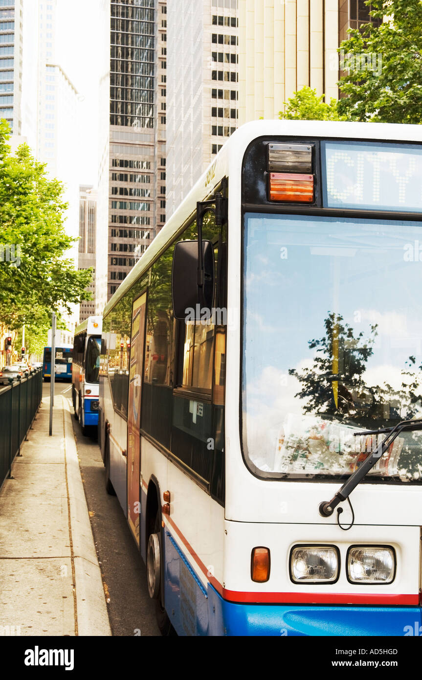 Bus stop on an urban city street, bus in foreground no visible people ...
