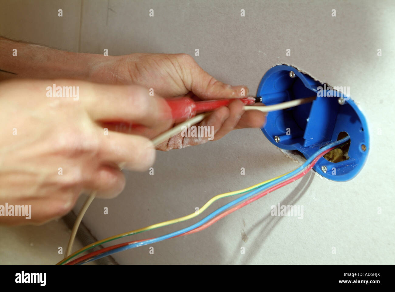 Electician installing wires Stock Photo - Alamy