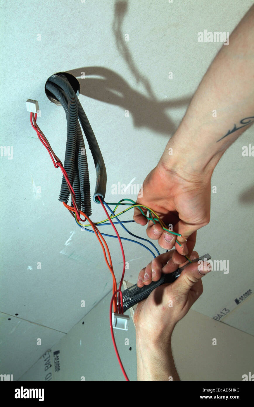 Electician installing wires Stock Photo - Alamy