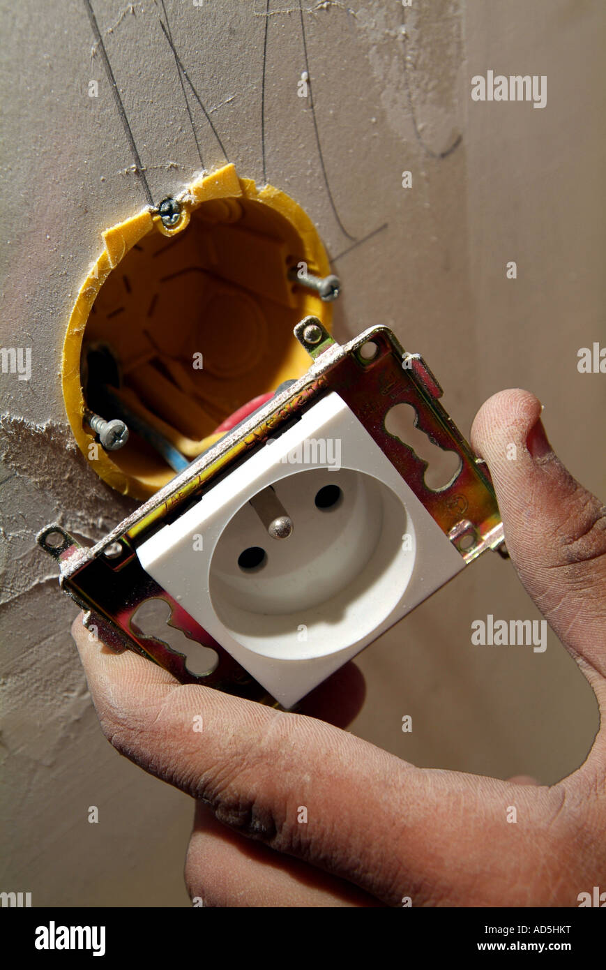 Electician installing a plug Stock Photo - Alamy