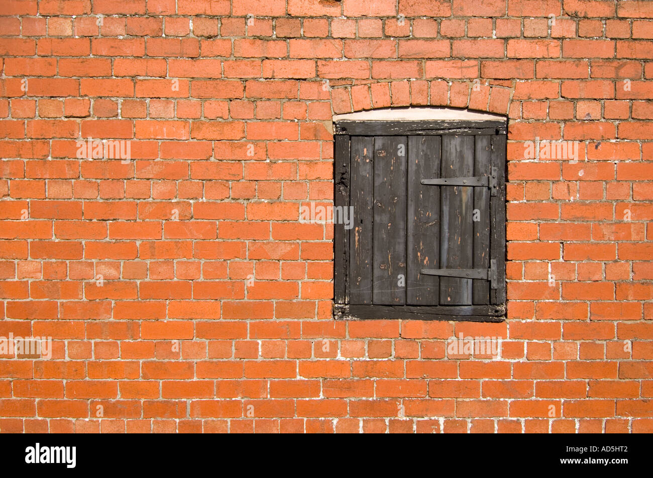 Wooden hatch for coal delivery in brick wall Llanidloes Powys Mid Wales ...
