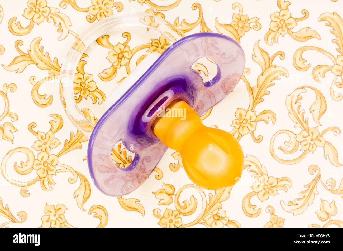 Gold baby dummy hi-res stock photography and images - Alamy