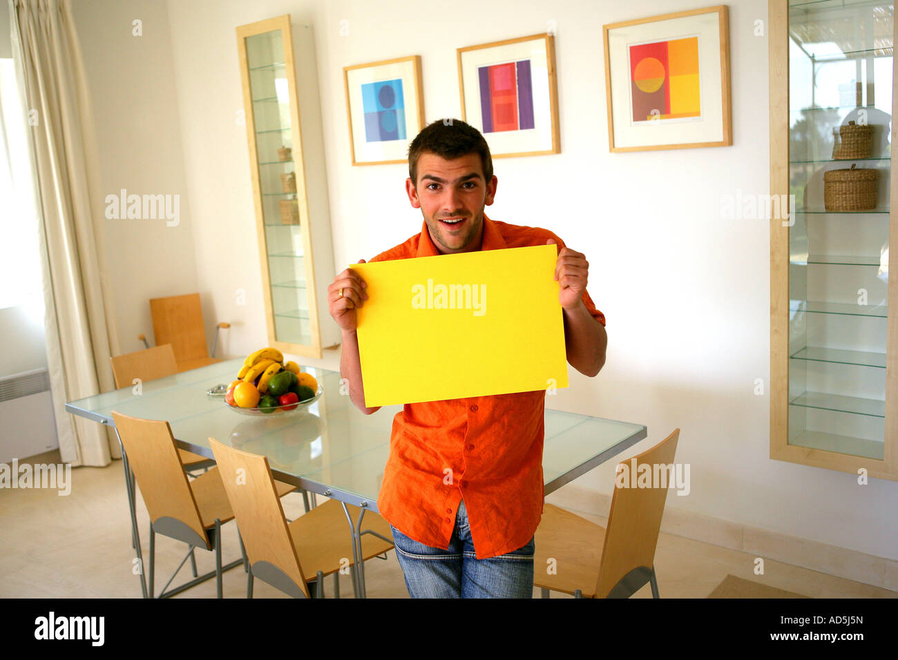 Man showing a yellow display board Stock Photo - Alamy