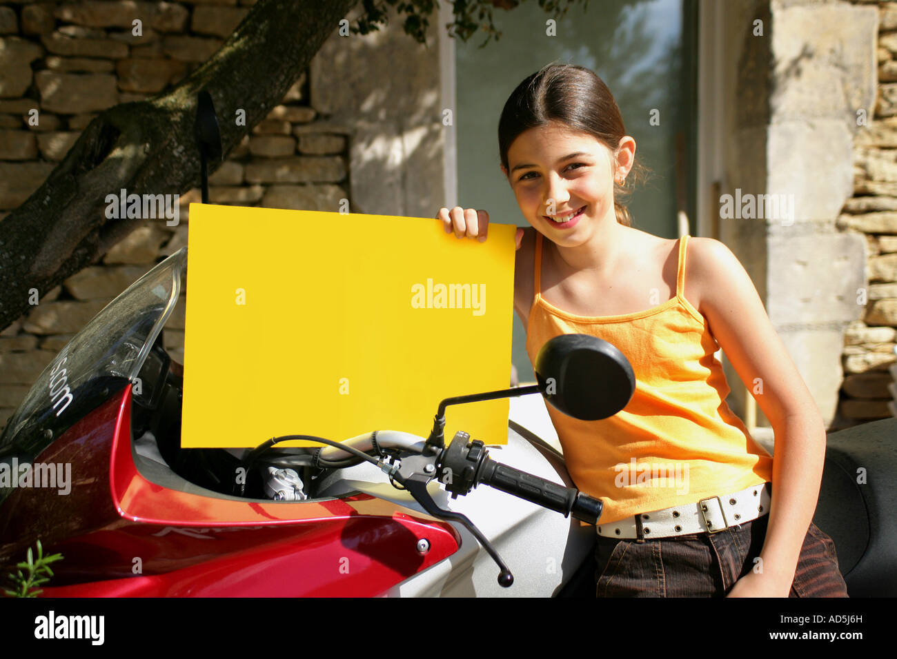 Girl showing a yellow display board Stock Photo - Alamy
