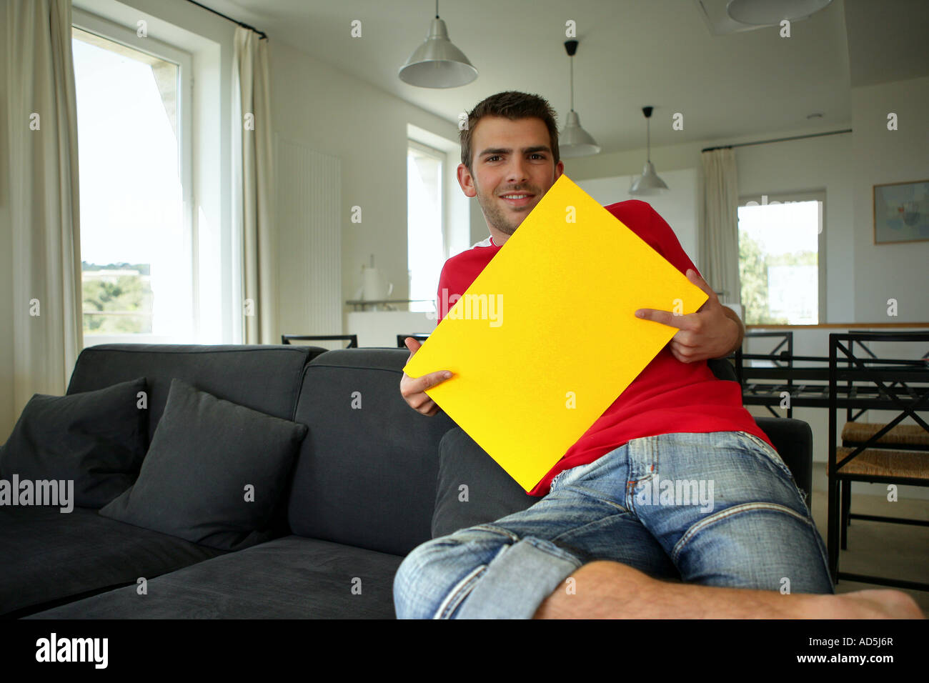 Man showing a yellow display board Stock Photo - Alamy