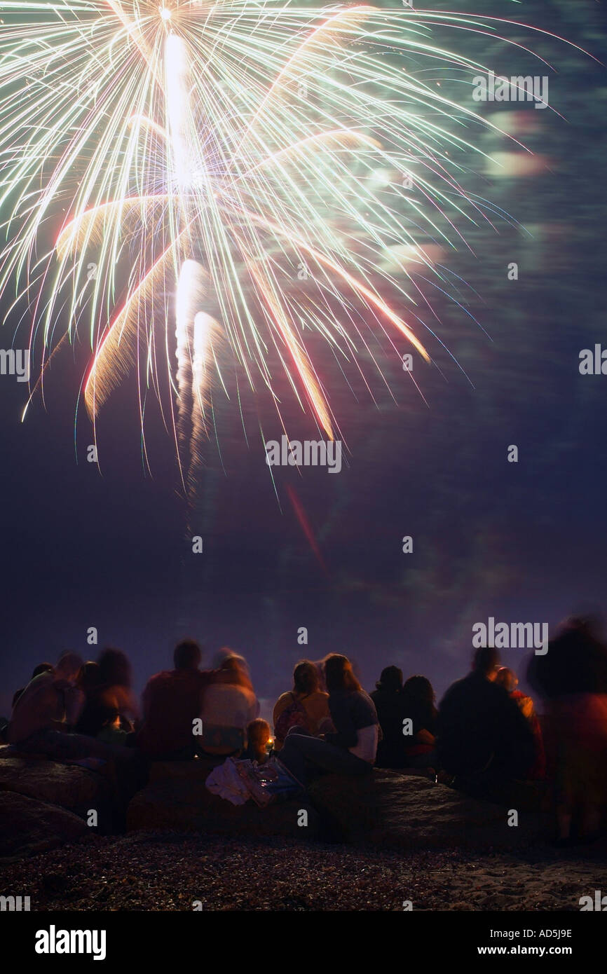 Fireworks over the beach with people watching holding sprinkers Stock ...