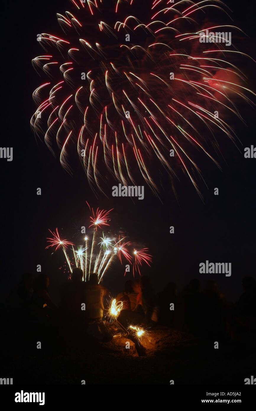 Fireworks over the beach with people watching holding sprinkers Stock ...