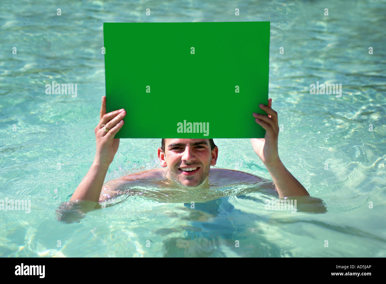 Man showing a display board in the swimming pool Stock Photo - Alamy