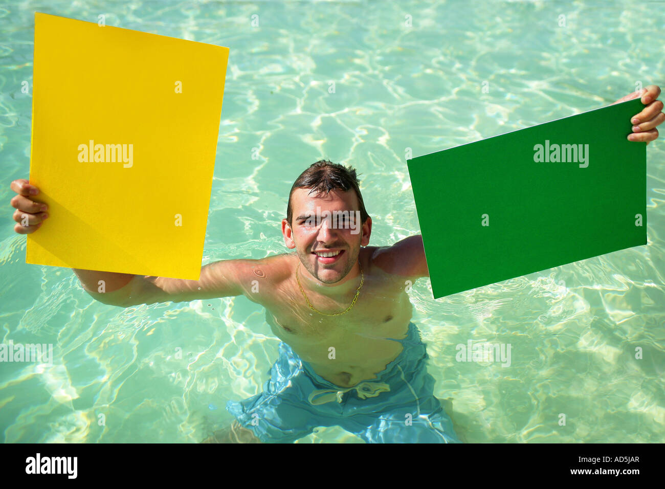 Man showing display boards in the swimming pool Stock Photo - Alamy