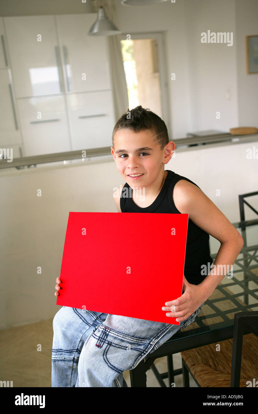 Boy showing a red display panel Stock Photo - Alamy