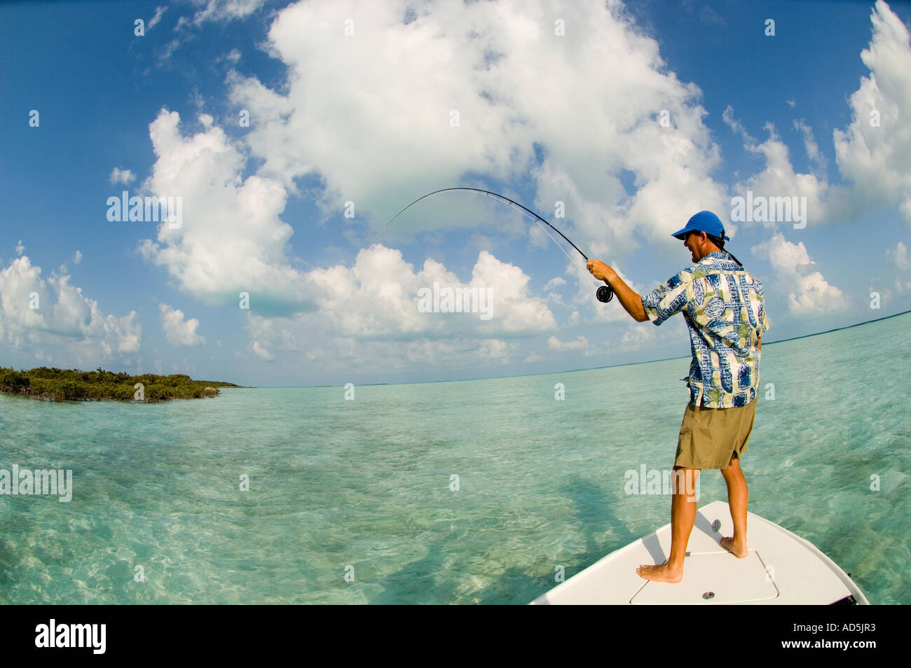 GREATER EXUMA BAHAMAS Fisherman fighting Bonefish on fly rod from ...