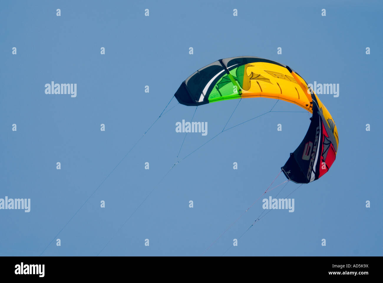 Horizontal view of a brightly coloured canopy from a kitesurfer ...