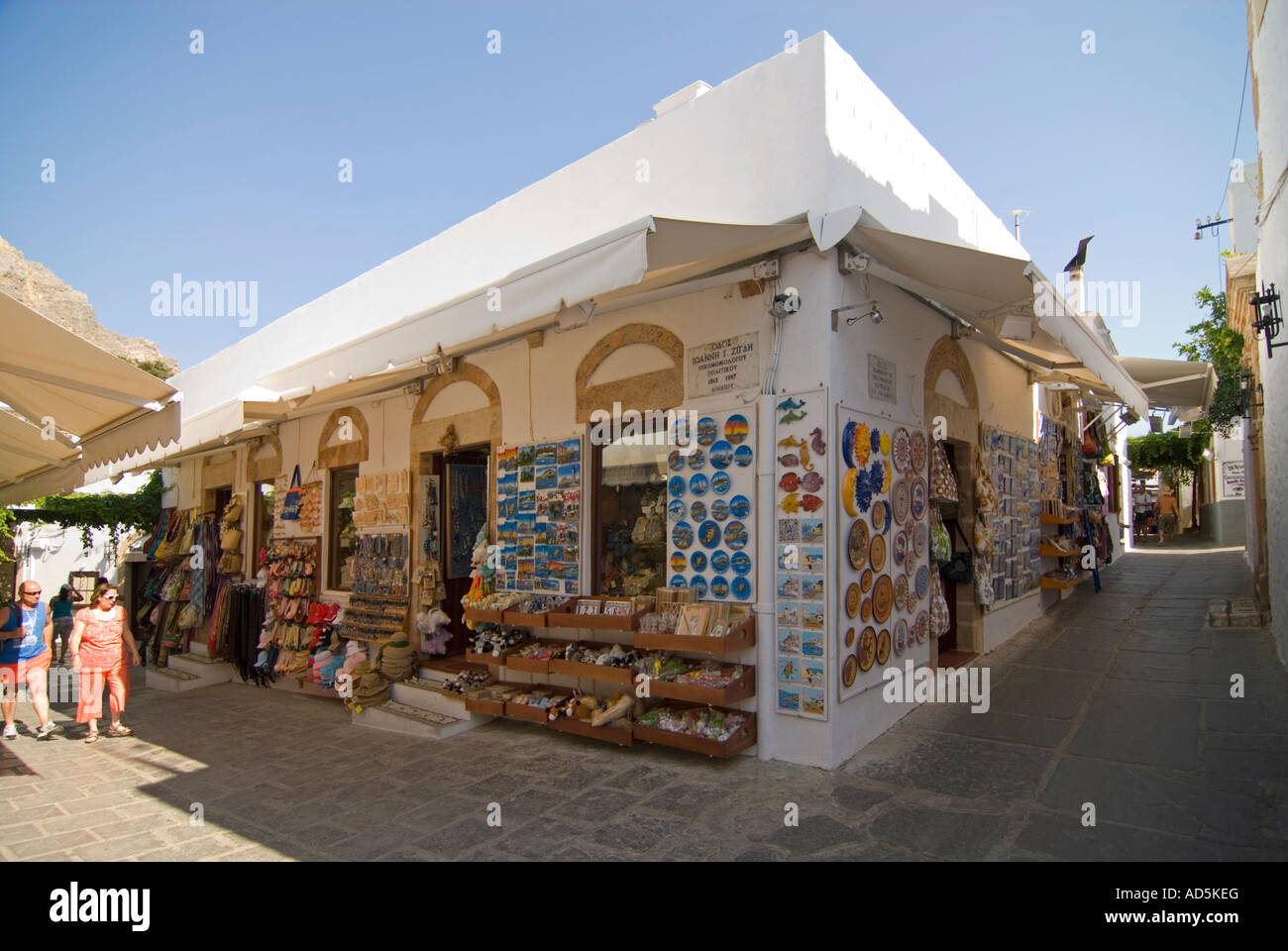 Horizontal wide angle of a narrow street corner in Lindos with a ...