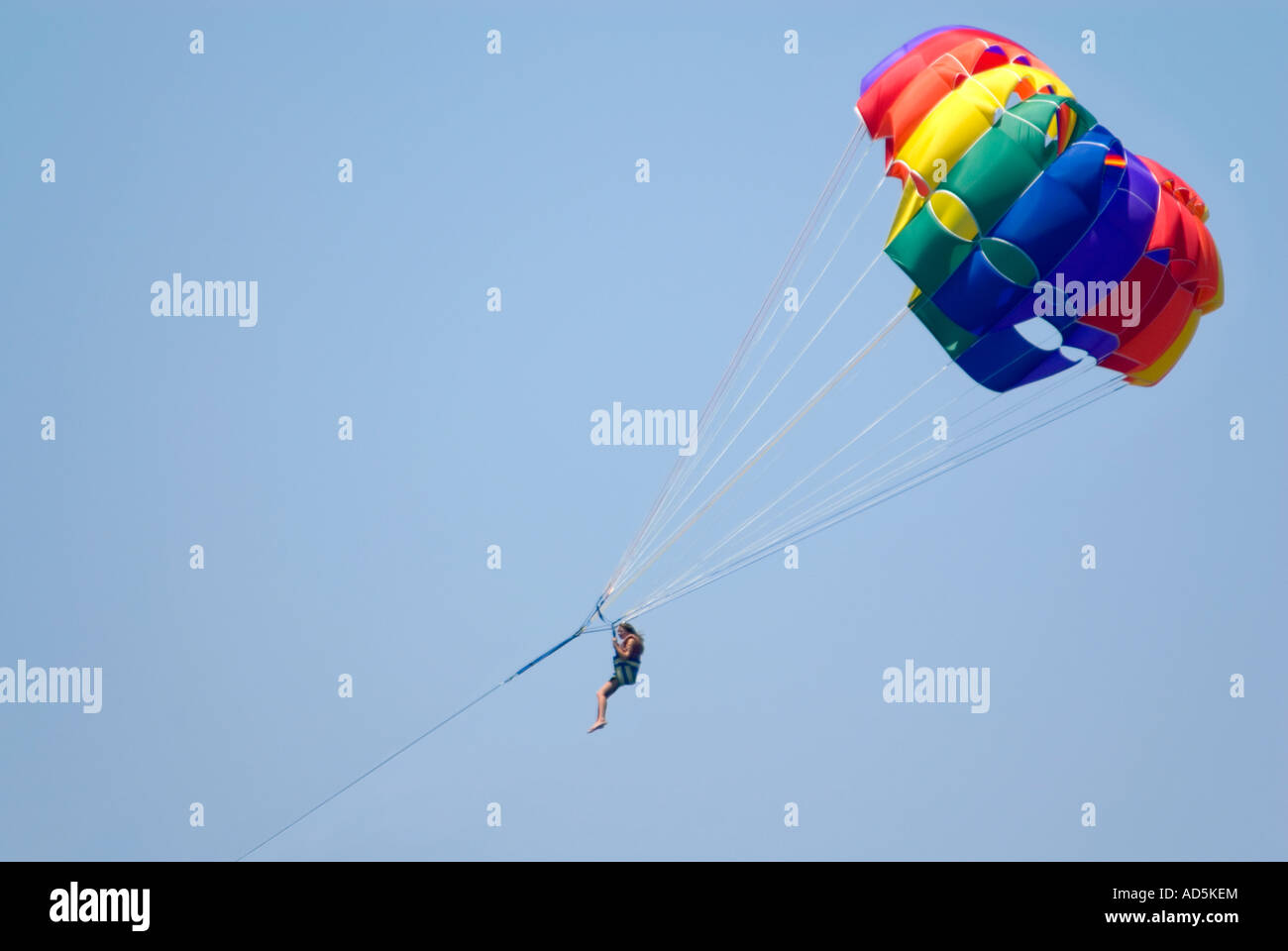 Horizontal close up of a young woman para-sailing, para sailing, with a ...