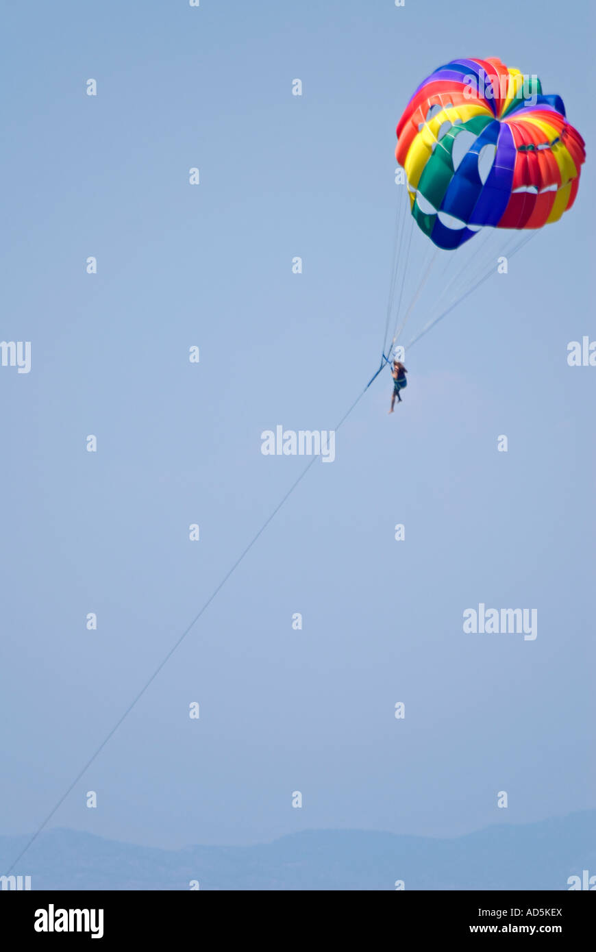 Vertical close up of a young woman para-sailing, para sailing, with a ...