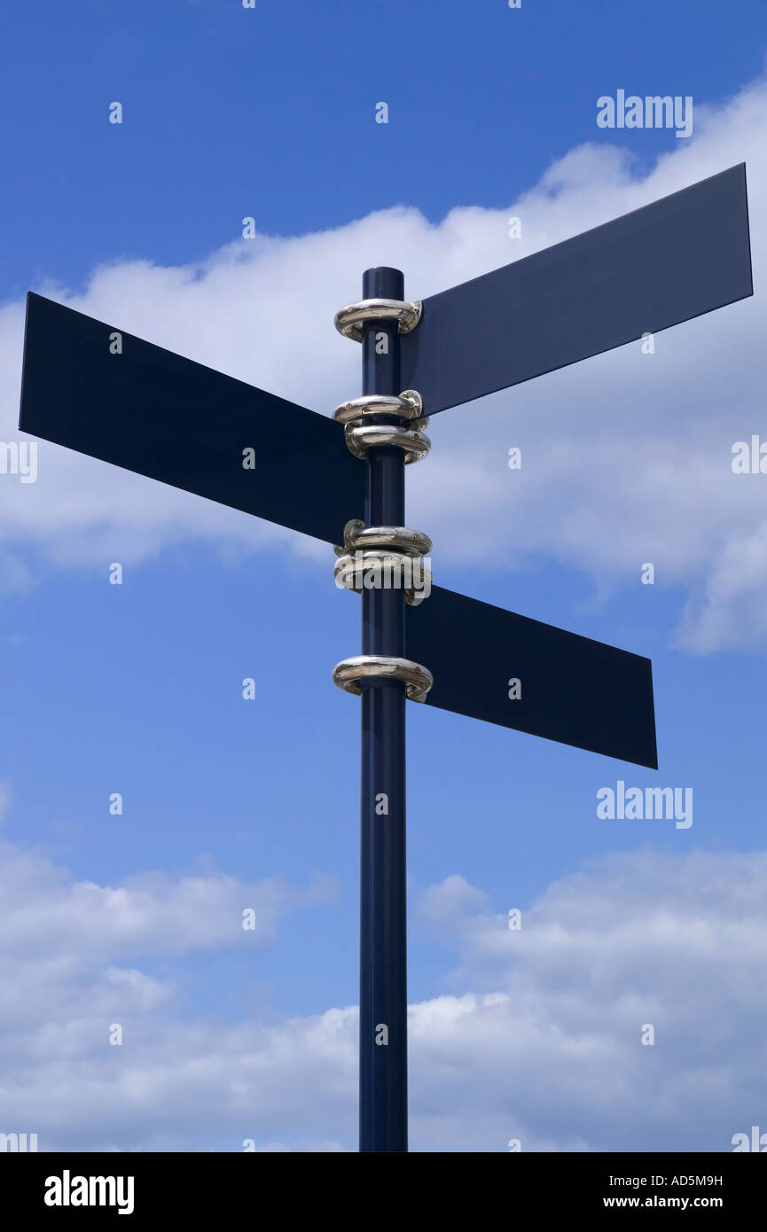 Blank Blue signpost against a blue cloudy sky With clipping path for ...